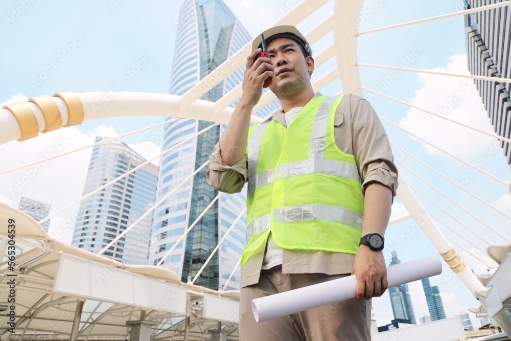 Engineers using walkie-talkie in construction site. civil engineer walk ...