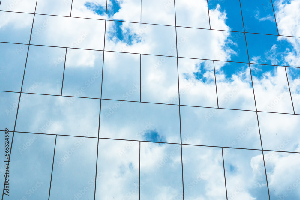 Blue sky reflection in glass facade of building. View of office ...