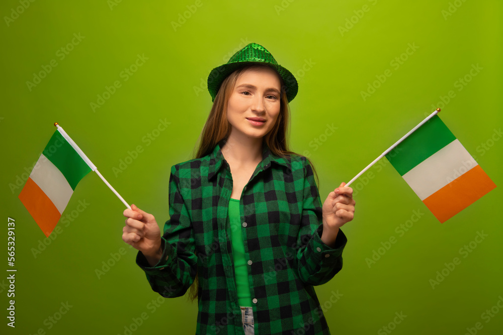 Young irish woman in green checkered plaid shirt and hat holding two ...