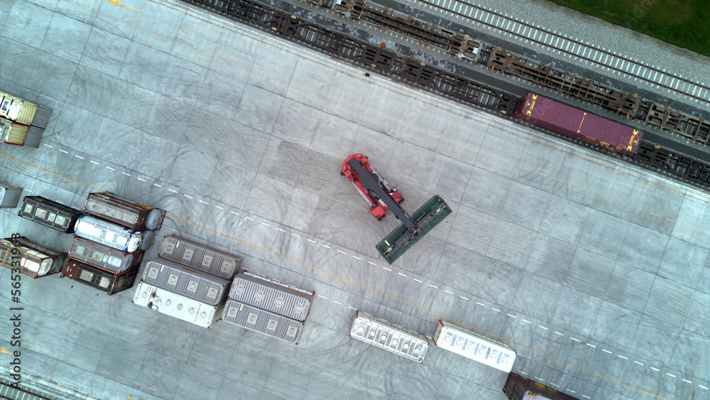 Aerial top down view crane loading container from container truck to ...