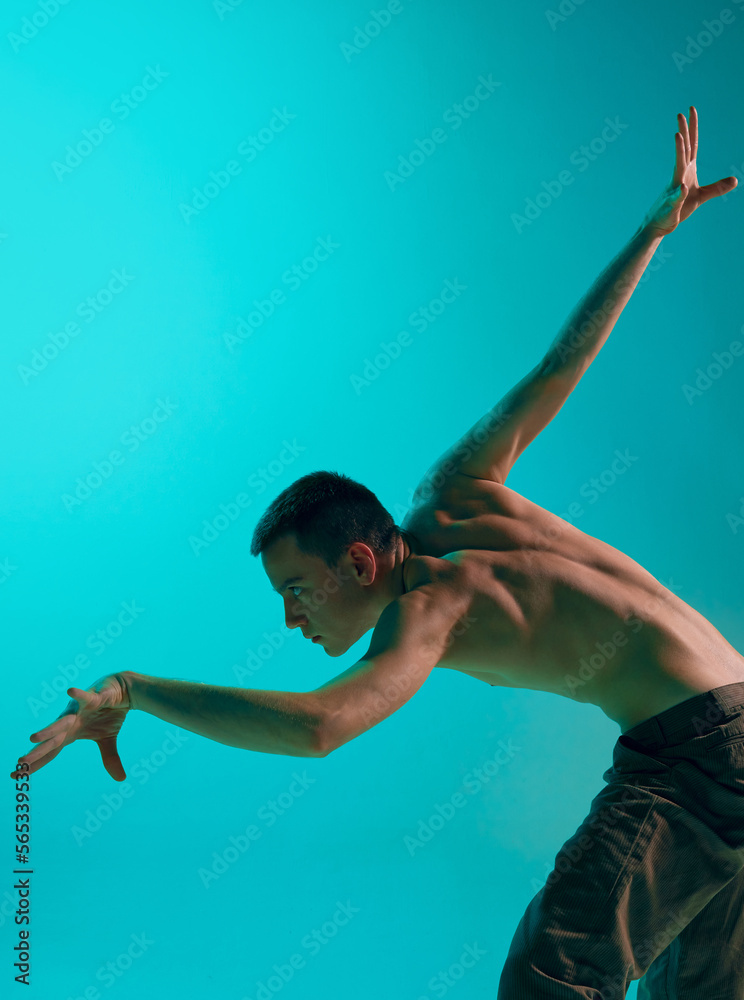 Contemporary dance style. Young shirtless, muscular man dancing over ...