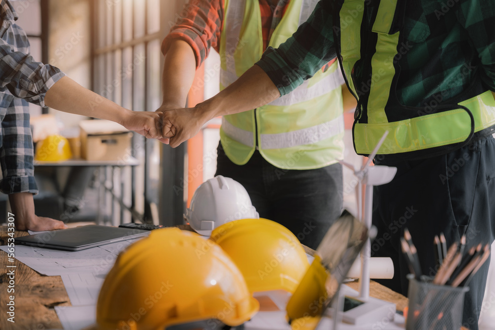 Team architects workers, men and women, join hands to join forces to ...