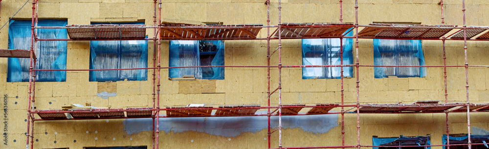 Wall insulation with mineral wool. Scaffolding, insulation of facades ...