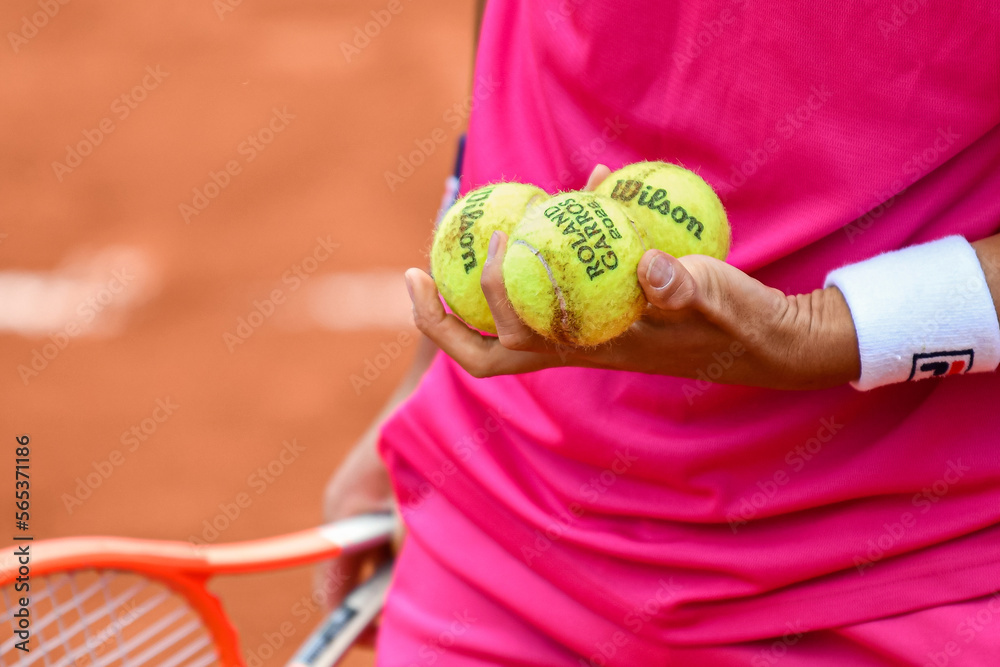The body of a player about to serve with his racket and Wilson balls in ...