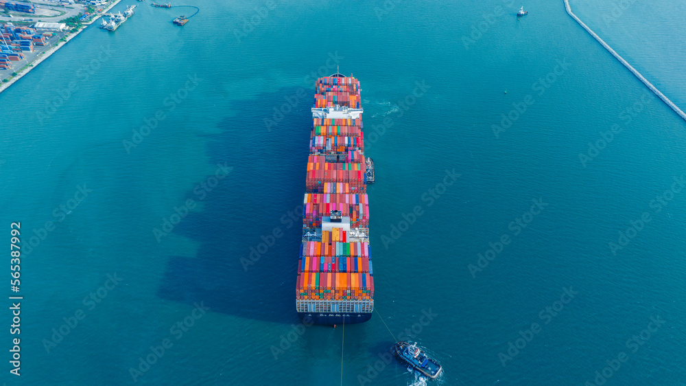 Tub Boat with Stern of cargo ship carrying container and running for ...