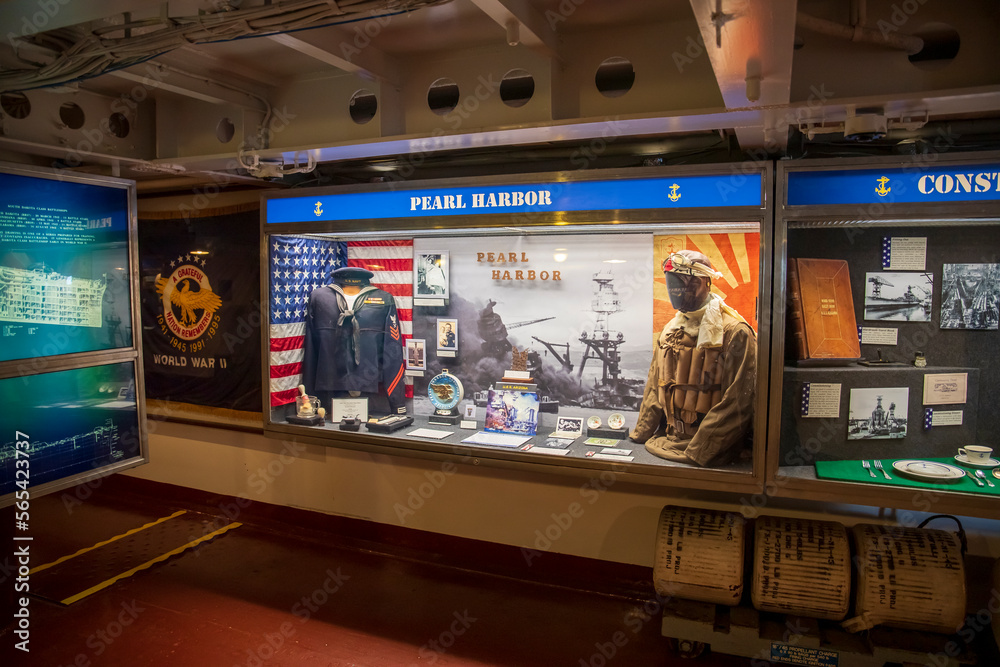 Inside the first deck of the USS Alabama Battleship with display cases ...