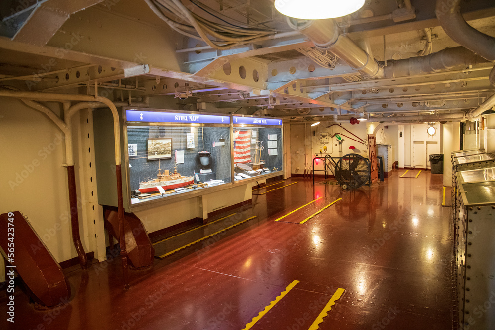 Inside the first deck of the USS Alabama Battleship with display cases ...