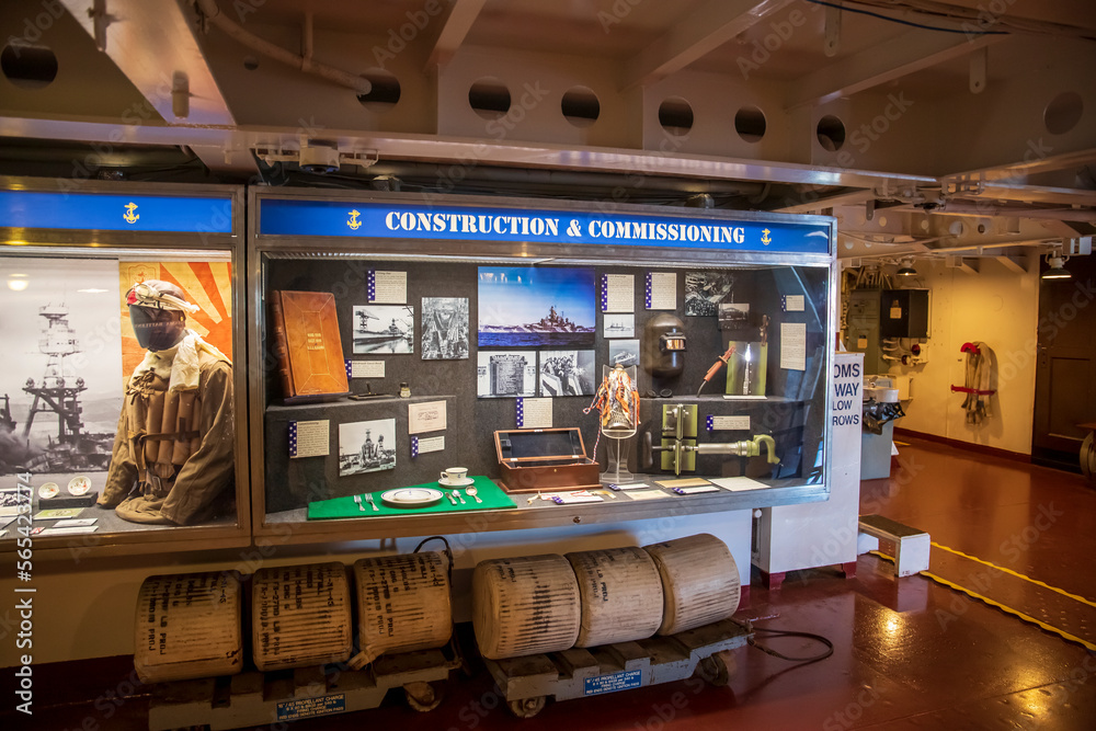 Inside the first deck of the USS Alabama Battleship with display cases ...