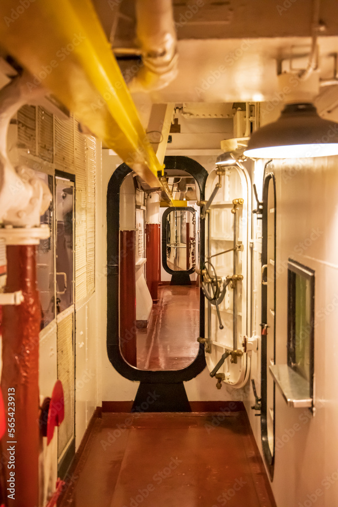 Inside of the USS Alabama Battleship with a long walkway with open ...