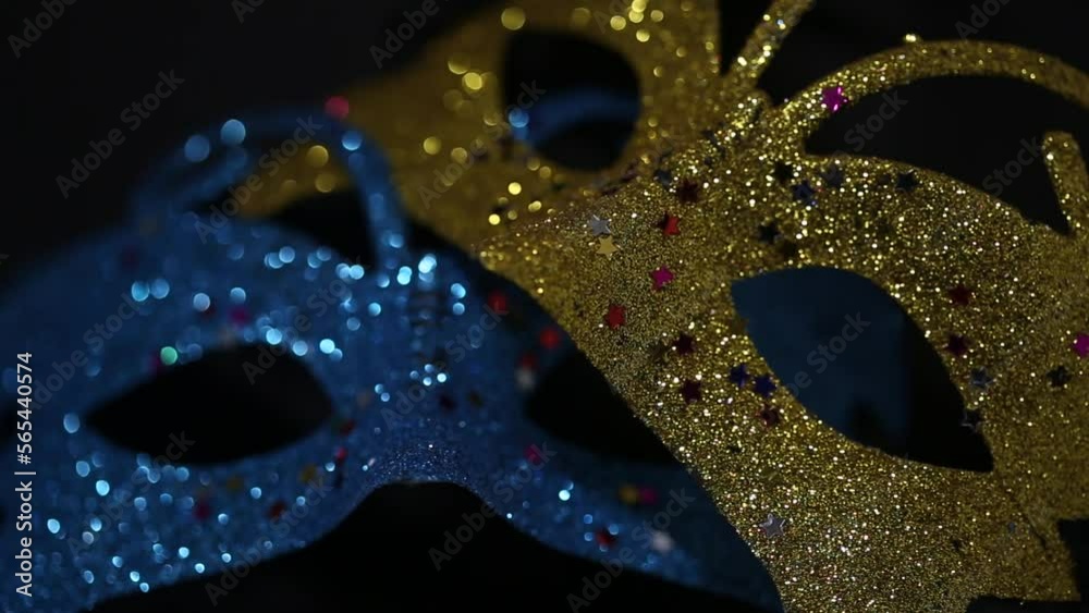 Two luxury traditional venetian masks on dark background illuminated ...