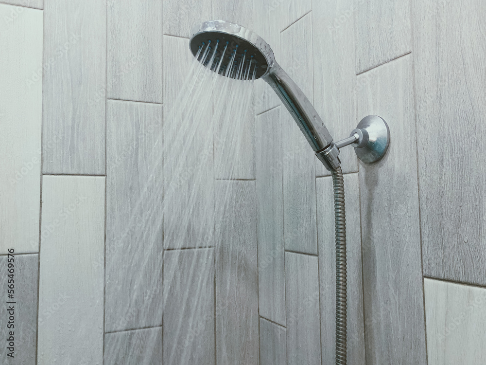 Water flowing from the shower head in the bathroom. Shower head and ...