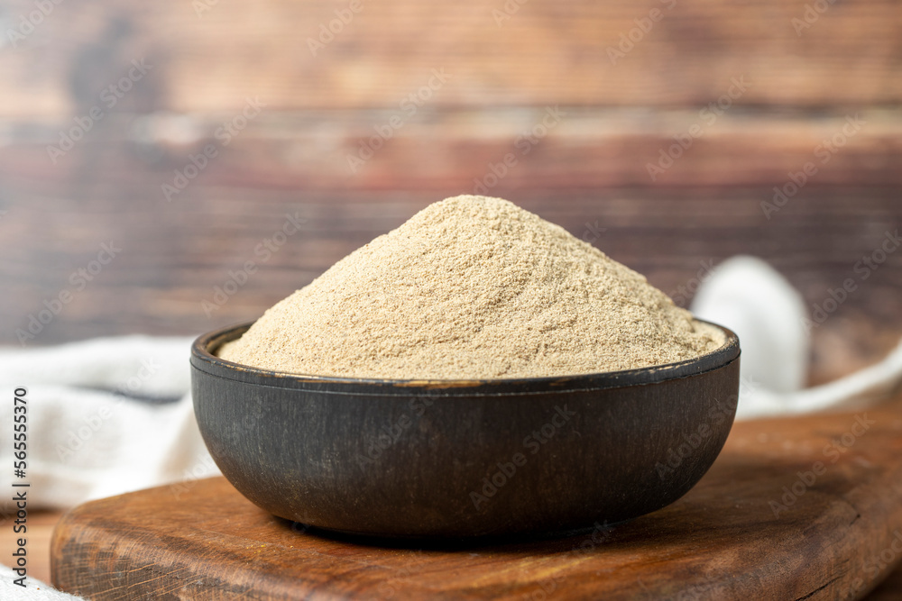 Powdered white pepper spice. Ground powdered white peppercorns in a ...