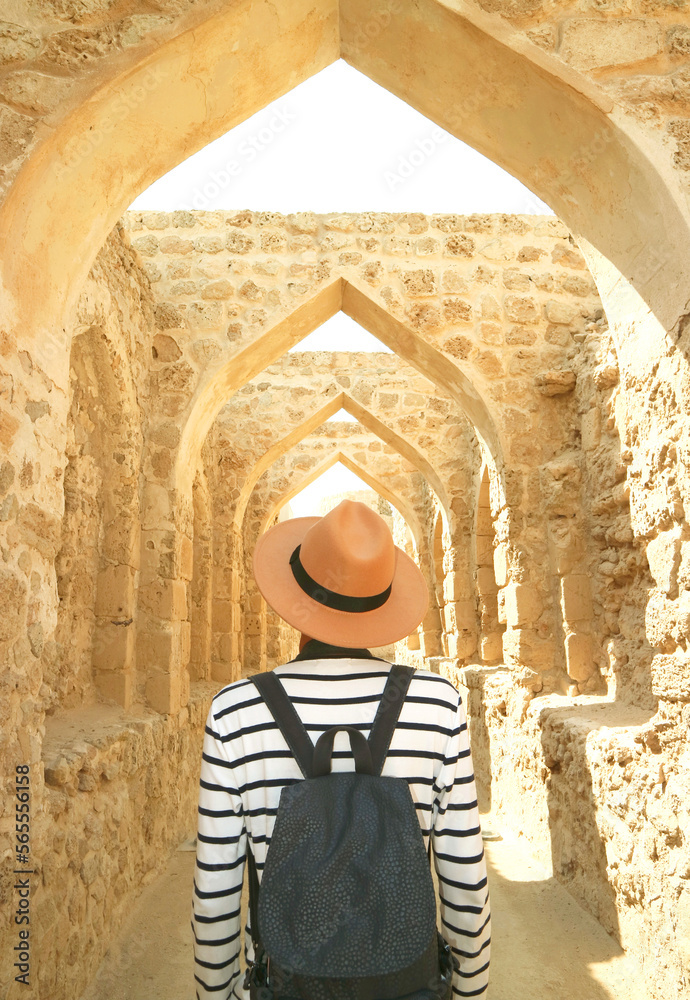 Visitor Walking Along the Iconic Archways of Qal'at al-Bahrain Or the ...