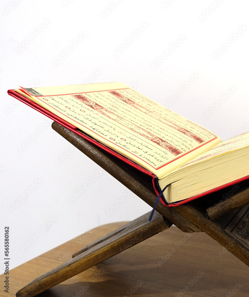 The holy book of Islam, the Holy Quran, on a wooden lectern, the open ...