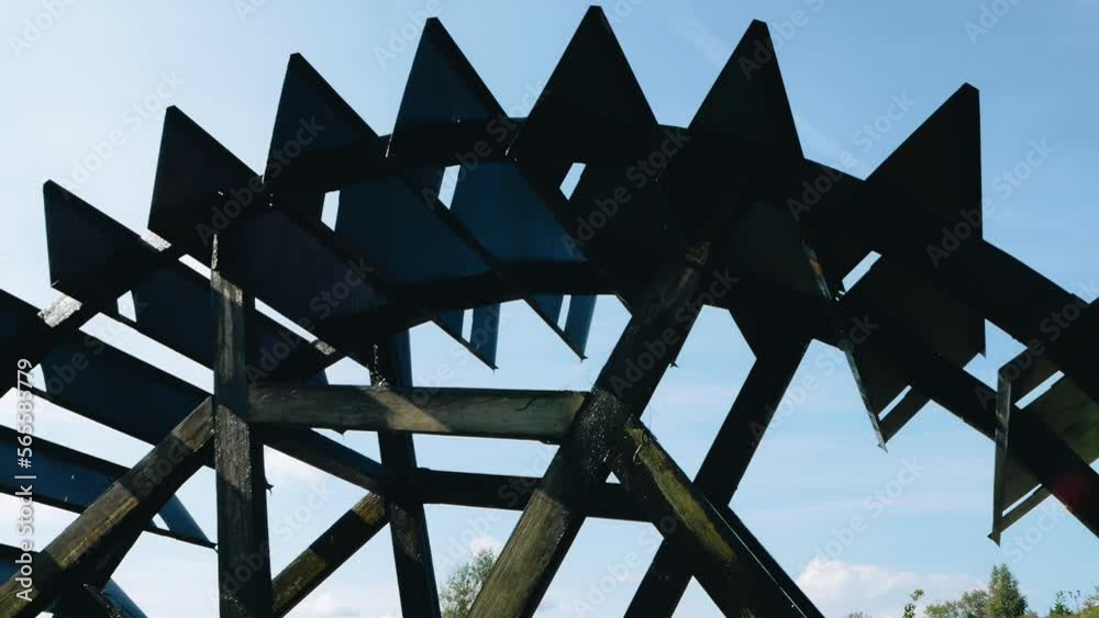 Rotating water wheel on a water mill. Shooting the mechanism in motion ...