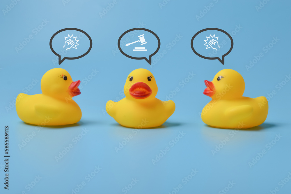 Toy duck characters fighting over one person. Avoidance bullying ...