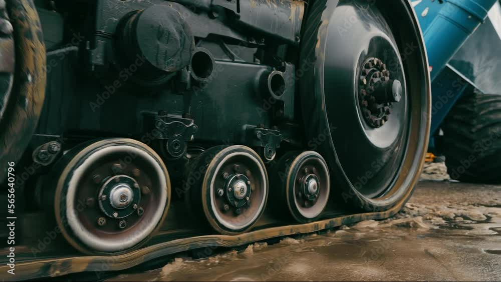 Caterpillar wheels of large-sized equipment close-up. The movement of ...
