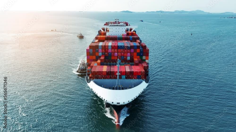 Aerial front view of smart cargo ship carrying container and running ...