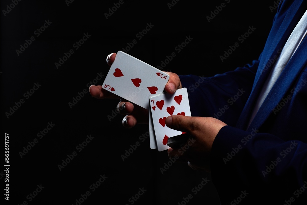 Magician illusionist showing performing card trick. Close up of hand ...