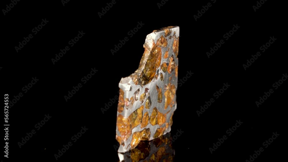 Rotating Of An Iron Meteorite. black background on a mirror base ...