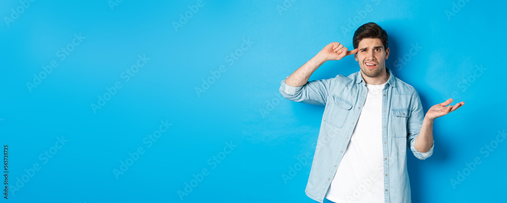 Confused man scolding person for being stupid, pointing finger at head ...