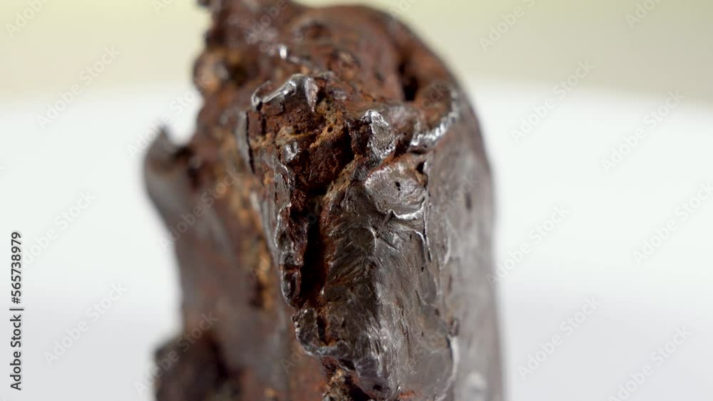 Rotating Of An Iron Meteorite. White background on a white base. Close ...