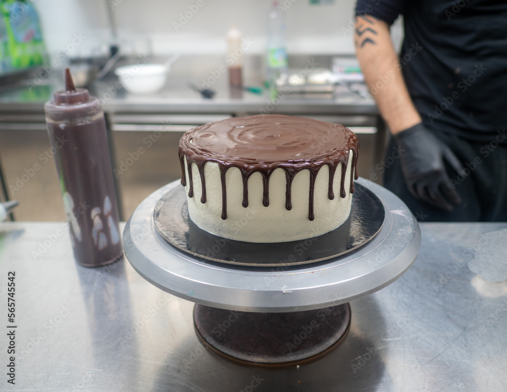 cake pastry chef designer decoration a dark chocolate frosted icing ...