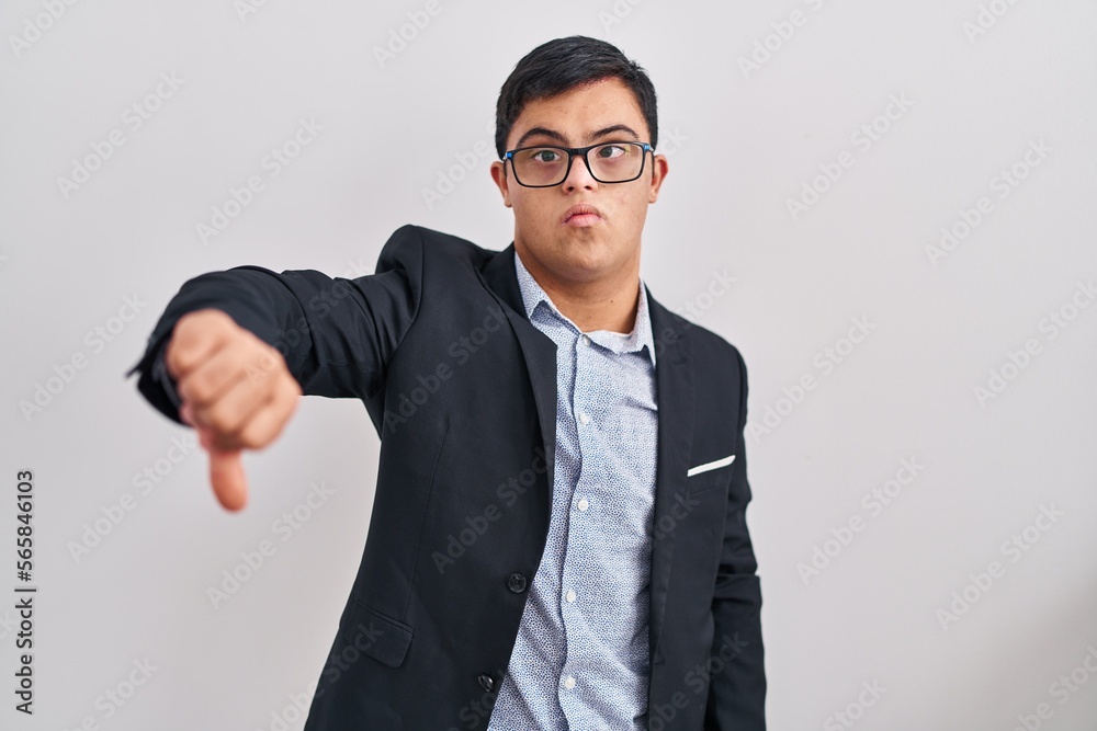 Young hispanic man with down syndrome wearing business style looking ...