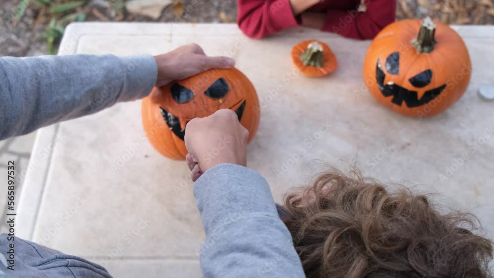 Preparing pumpkin for Halloween. Mother with children drawing out ...