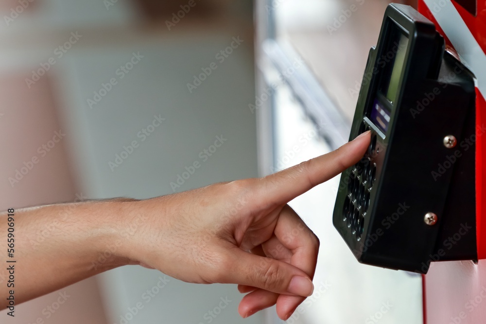 Hand pushing number button on vending machine operation panel keyboard ...