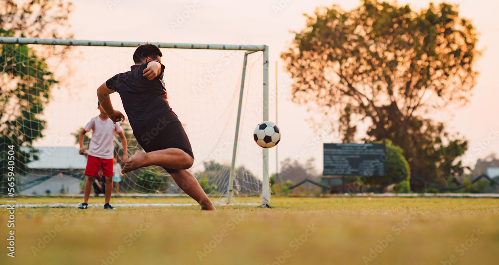 An action sport of a group of kids playing soccer football for exercise ...
