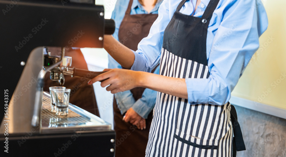 barita owner of the coffee shop makes Americano coffee from the coffee ...