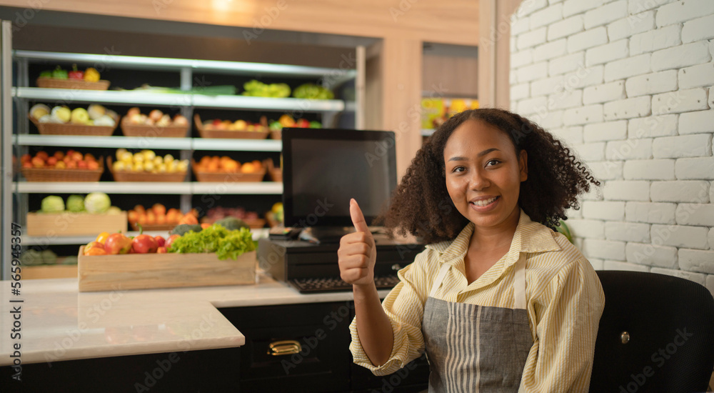 Portrait of a black african american woman working on cashier in a ...