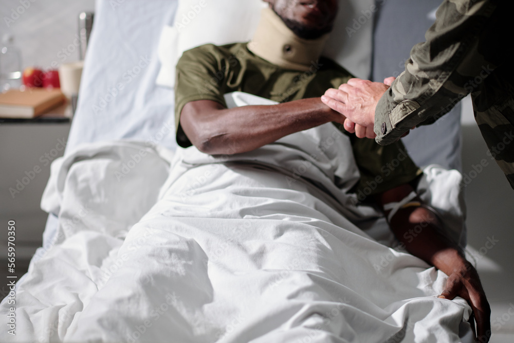 Sergeant telling thank you for your service to injured soldier lying on ...