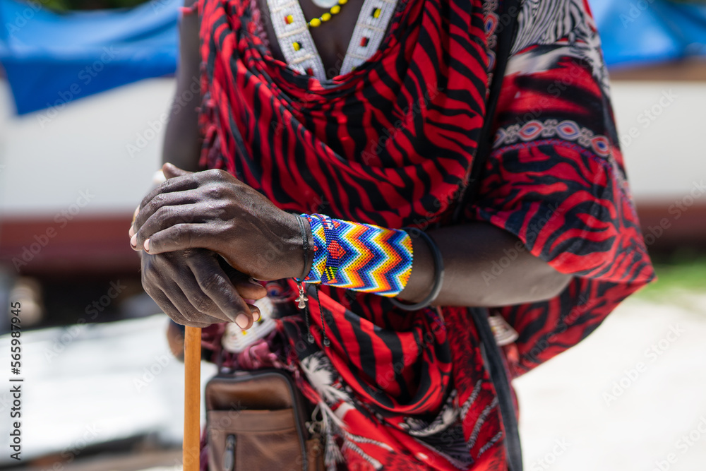 Maasai dressed in traditional clothes walking on the beach, Zanzibar ...