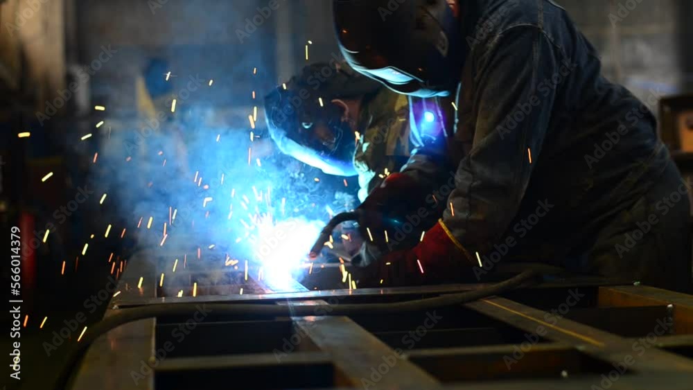 Workers wearing industrial uniforms and Welded Iron Mask at Steel ...