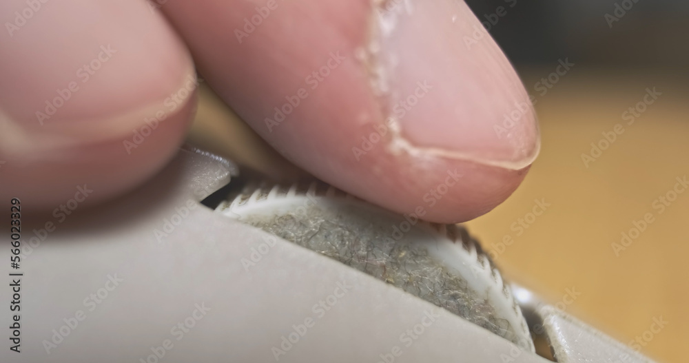 Finger scrolls the mouse wheel. Close-up, macro, side view. Dirty ...