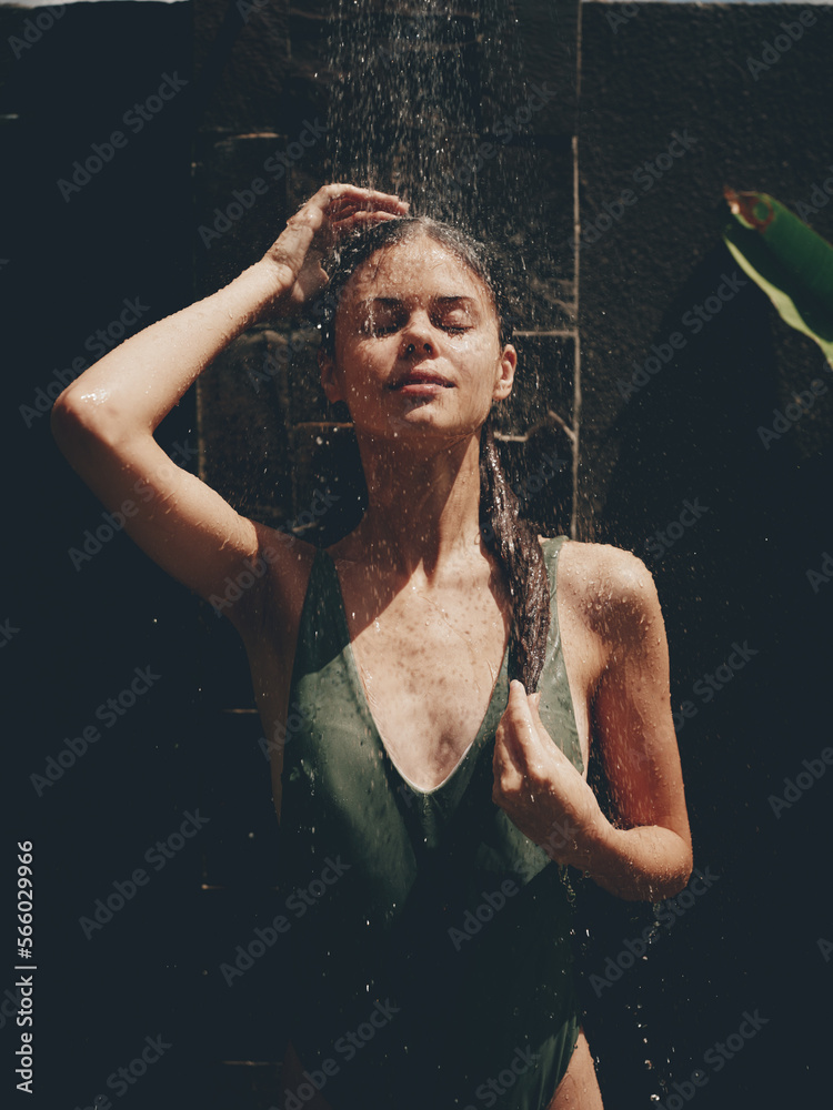 Sexy Woman Body In A Swimsuit Takes A Tropical Shower Outdoors Against