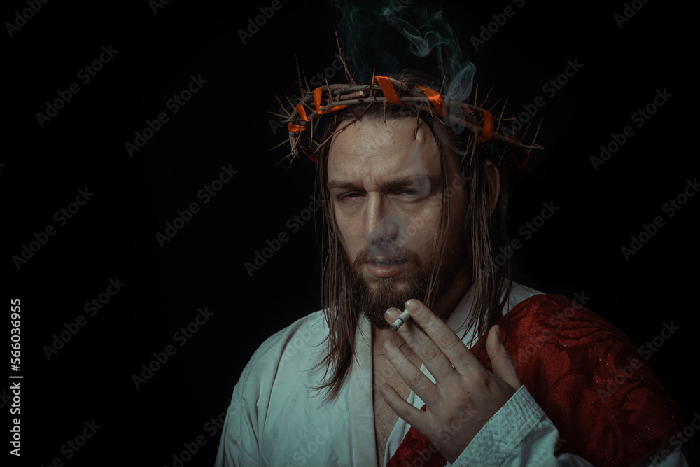 Jesus Christ smokes a cigarette wearing a crown of thorns and white ...