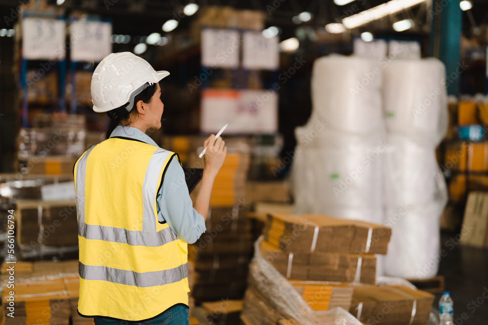 Portrait from back side of Asian woman warehouse supervisor working ...