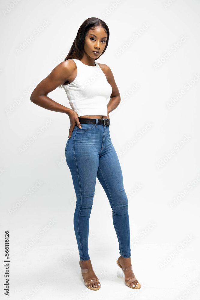 model in neutral clothing in front of white photography backdrop ...