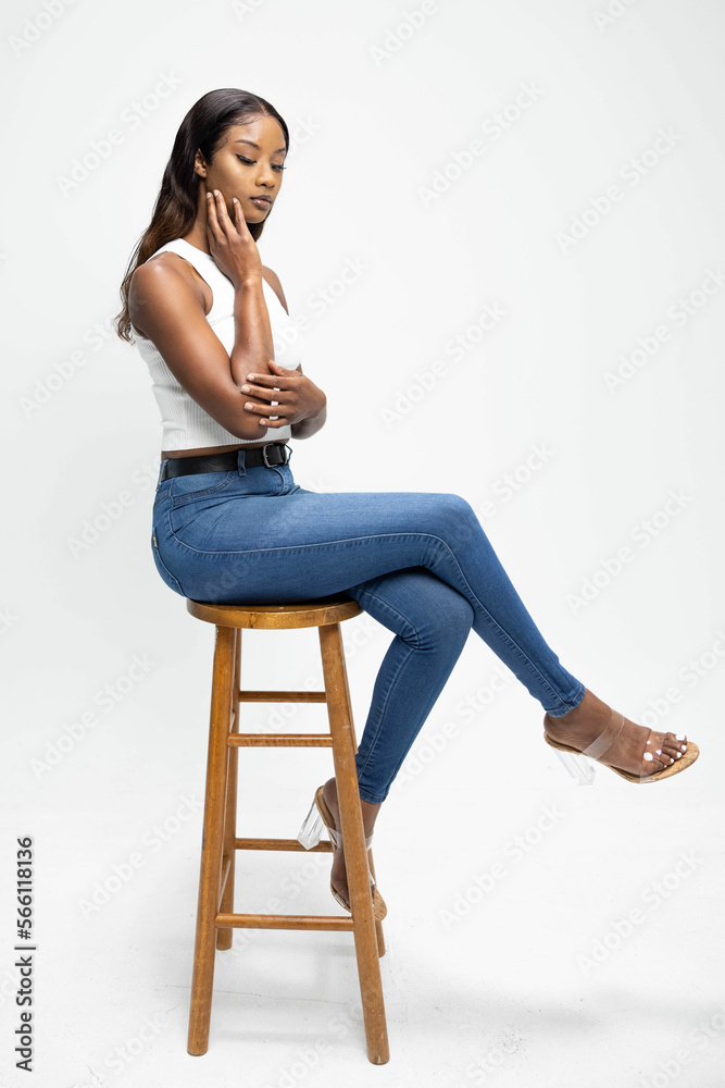 model in neutral clothing in front of white photography backdrop ...