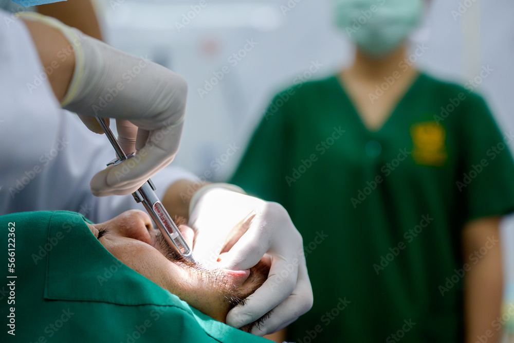 Dentist injecting anesthesia Dentist treating patient in dental office ...