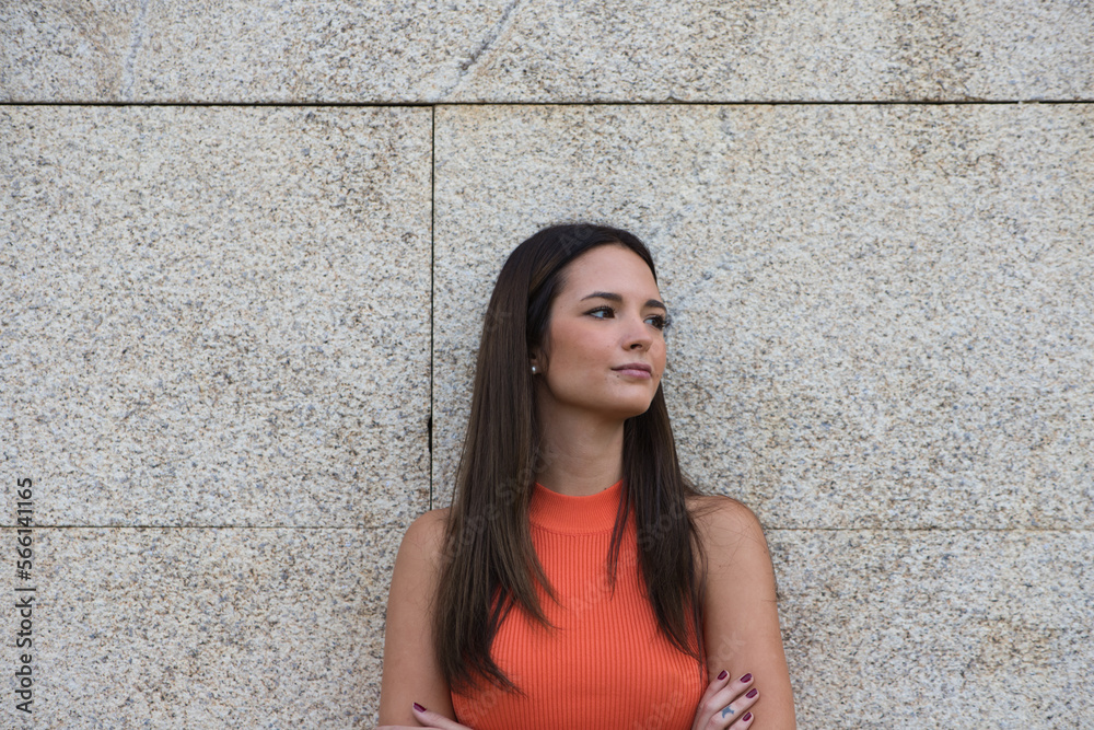 young beautiful woman leaning on a wall makes different expressions ...