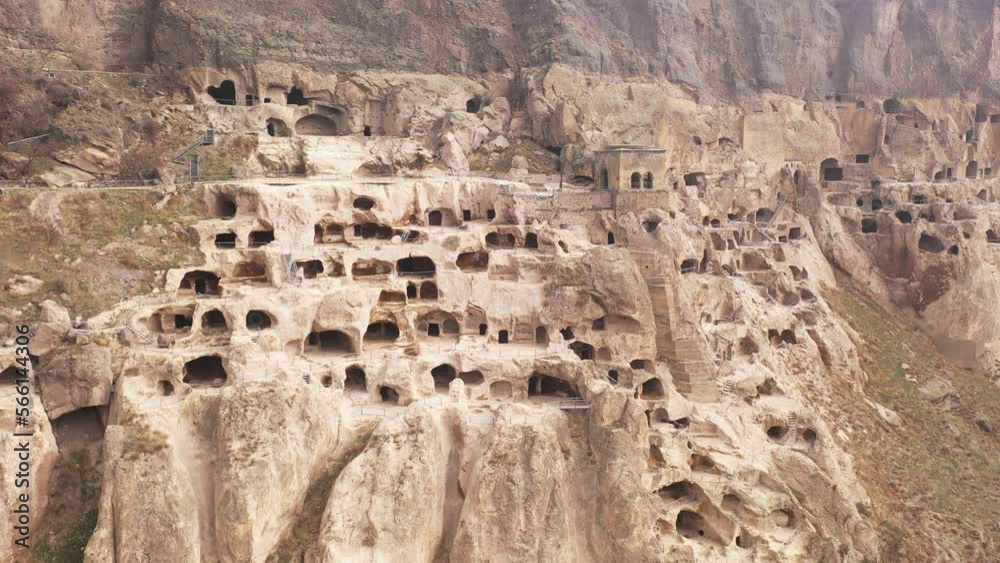 Complex of cave monastery structures carved into mountain in historic ...