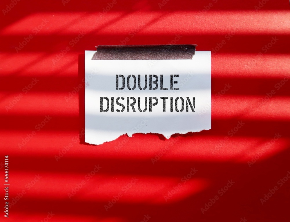 Stick note on red background with words DOUBLE DISRUPTION, massive ...