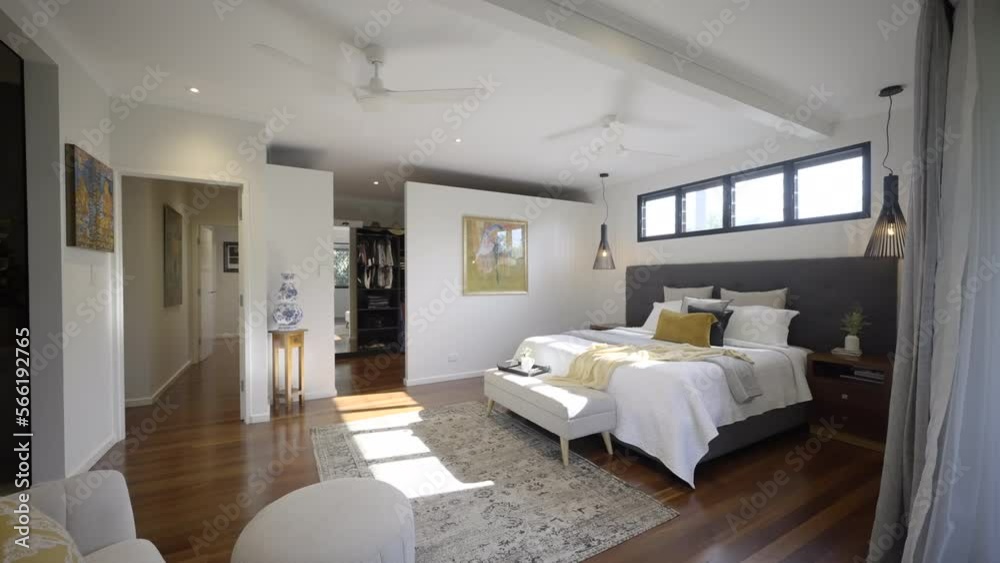 Contemporary modern bedroom with wooden floor boards. Walk in robe ...