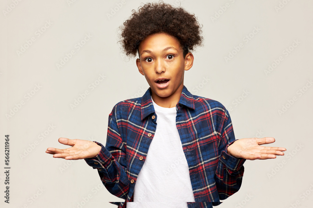 Teen african american boy in plaid shirt expressing his astonishment ...