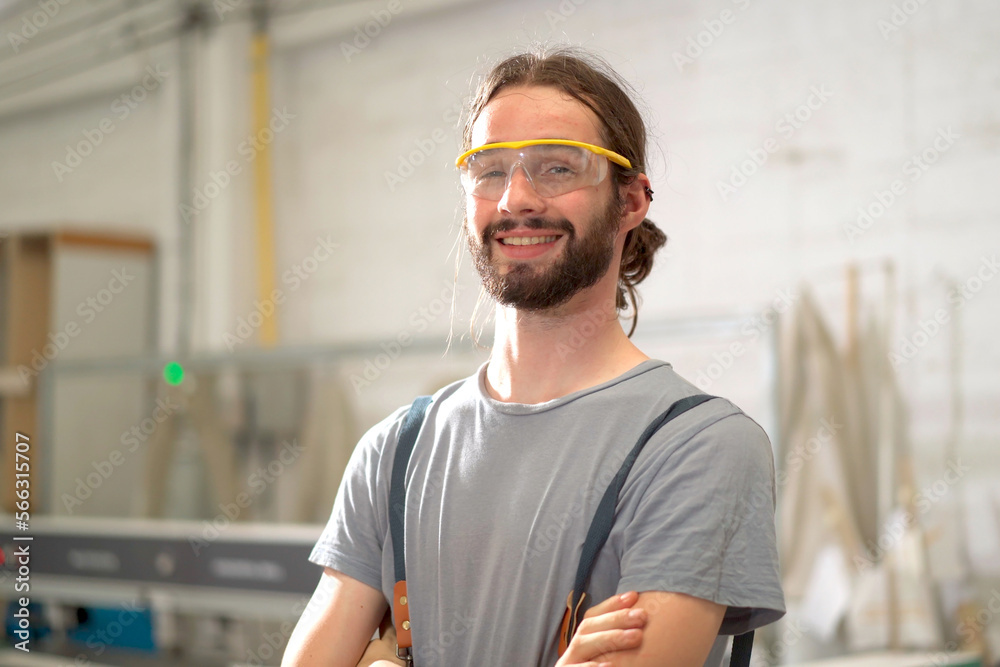 Professional male carpenter looking and smiling to camera. Happy ...