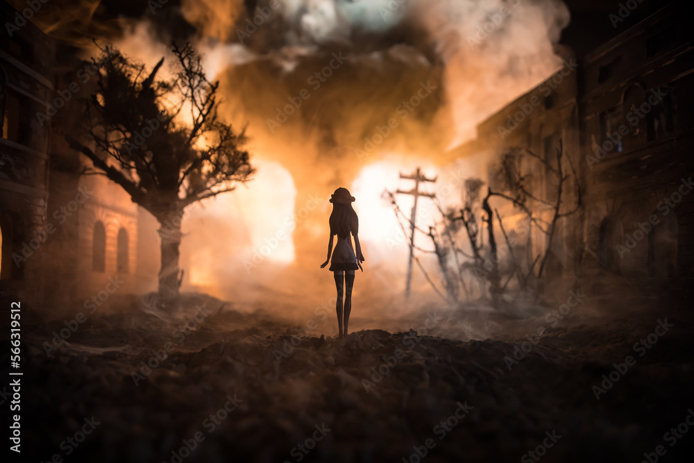 Artwork decoration. A man standing on a road of burnt up city ...